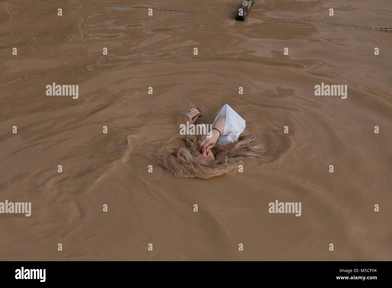 An Eastern Orthodox Christian pilgrim immersing herself in the water at ...