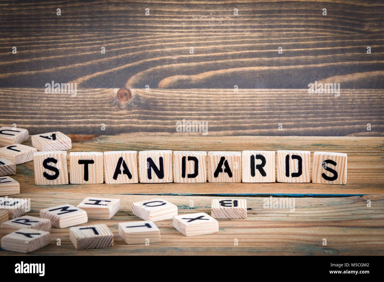 standards. Wooden letters on the office desk, informative and ...