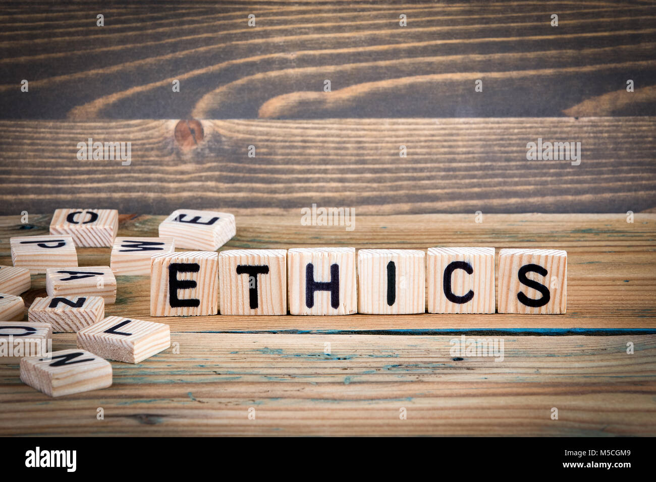 Ethics. Wooden letters on the office desk, informative and ...