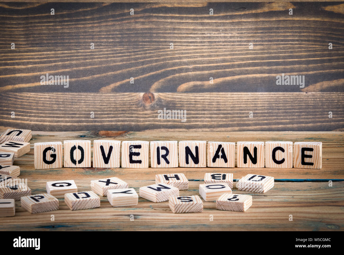 governance. Wooden letters on the office desk, informative and ...