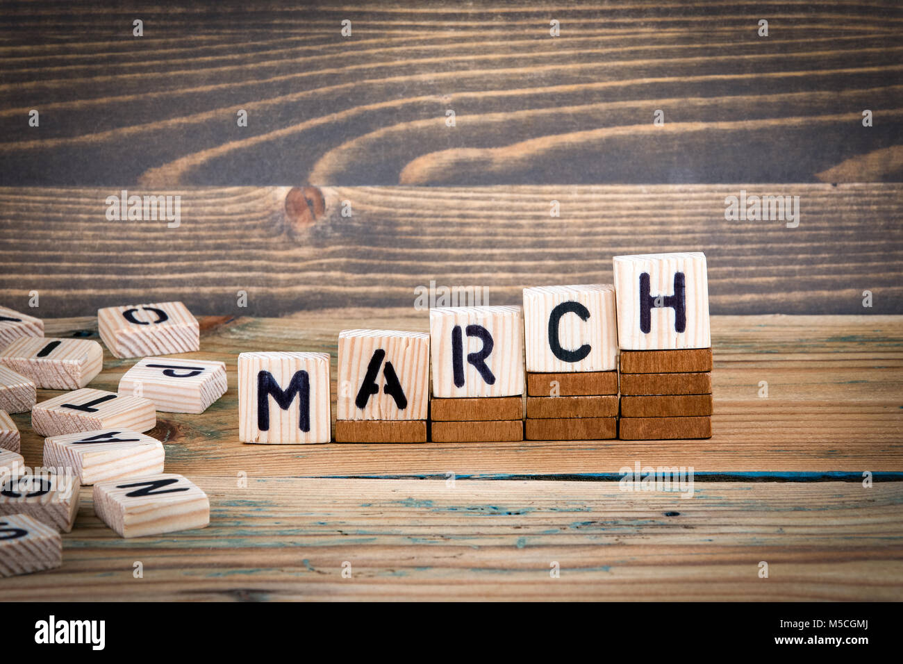 March. Wooden letters on the office desk, informative and communication ...