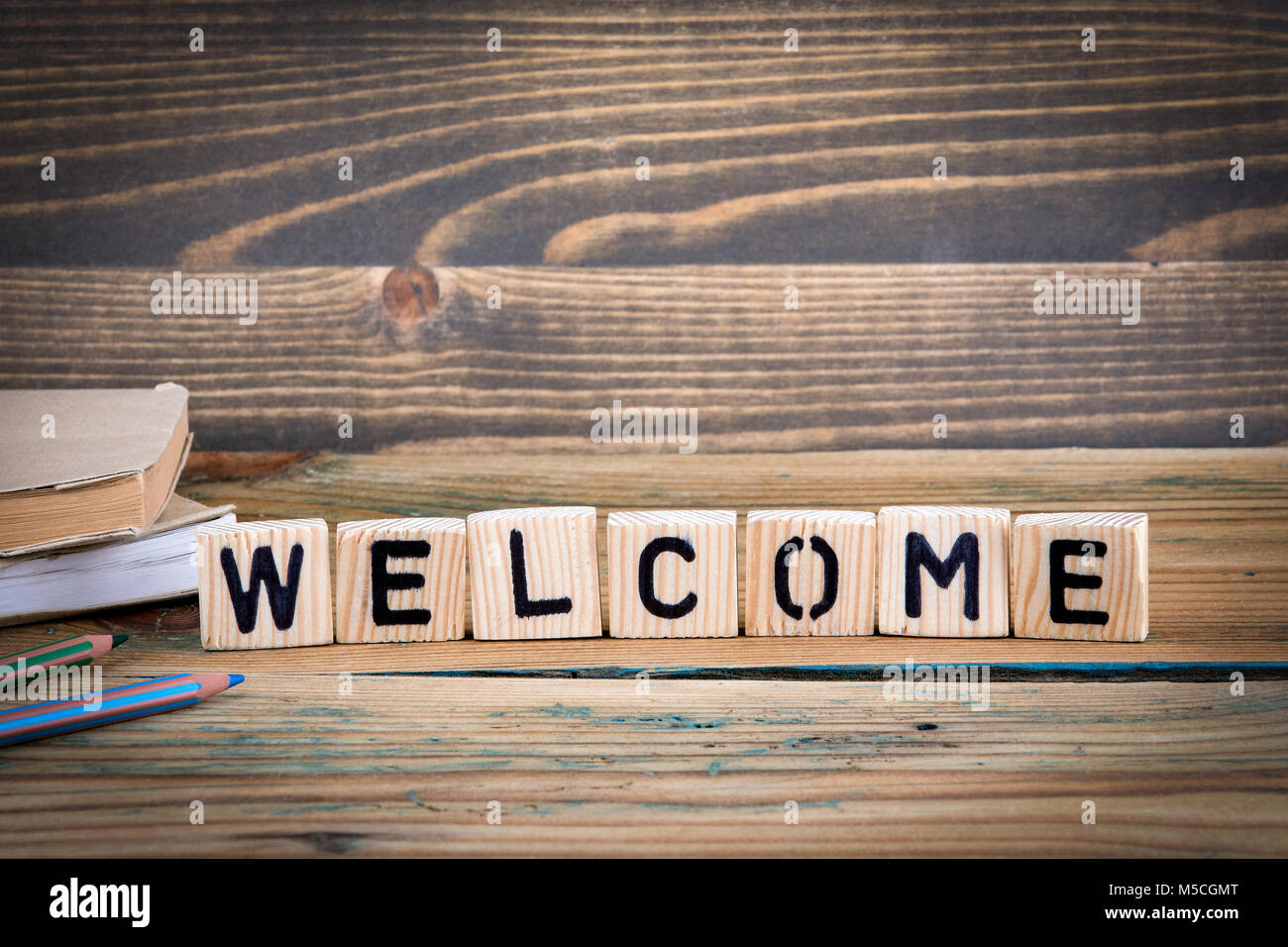 Welcome. Wooden letters on the office desk, informative and ...