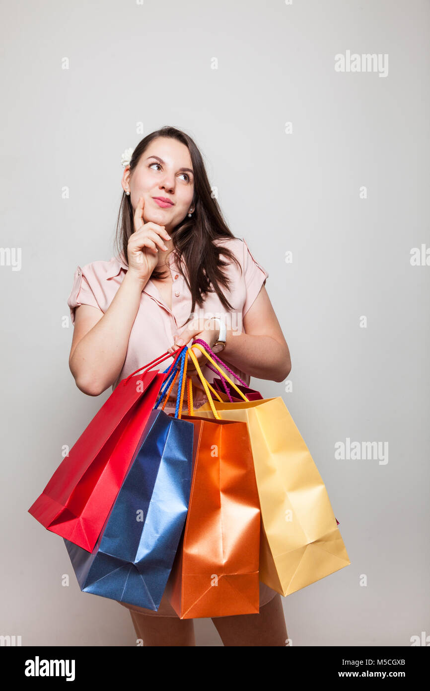 Beautiful young girl thinks about upcoming sales in stores Stock Photo ...