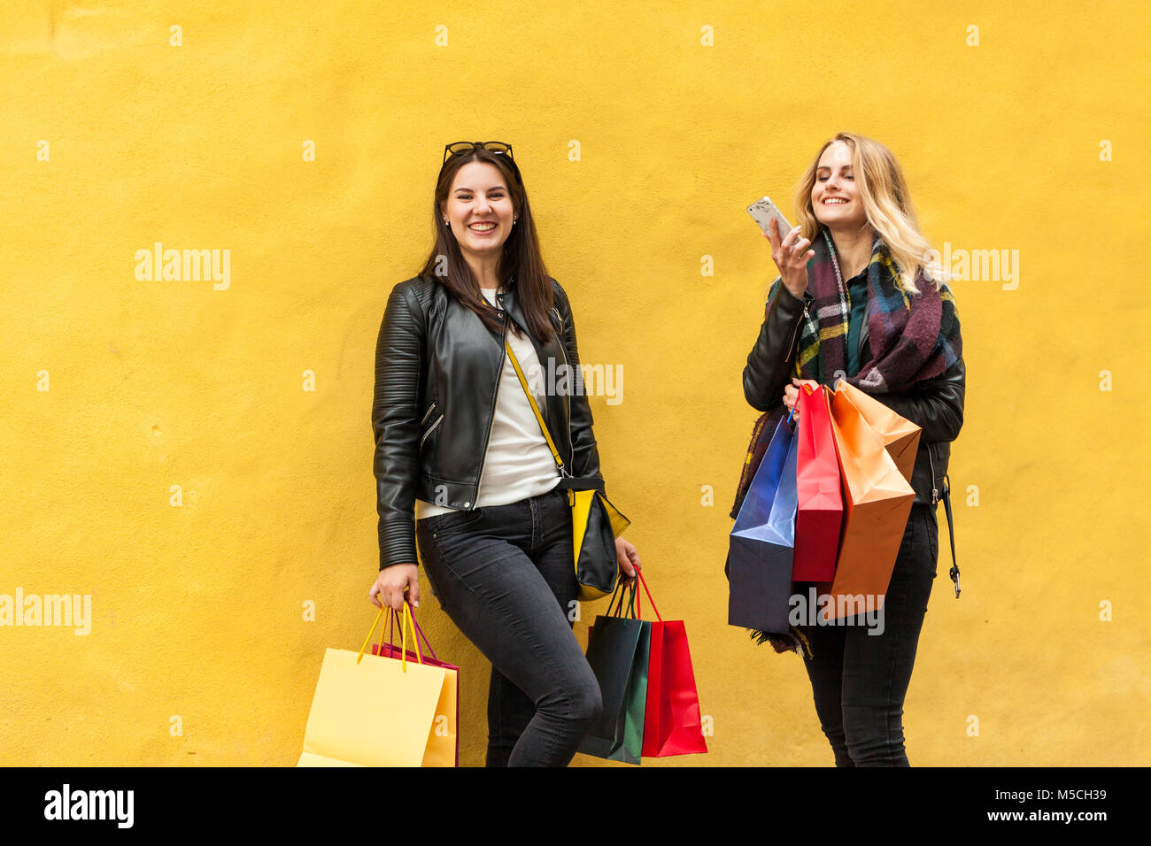 Cheerful caucasian girls are happy smiling outdoor with hands full with ...
