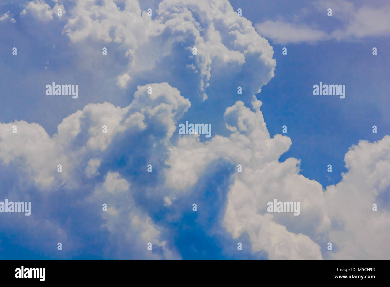 a series of white clouds that look like whipped cream/a cauliflower ...