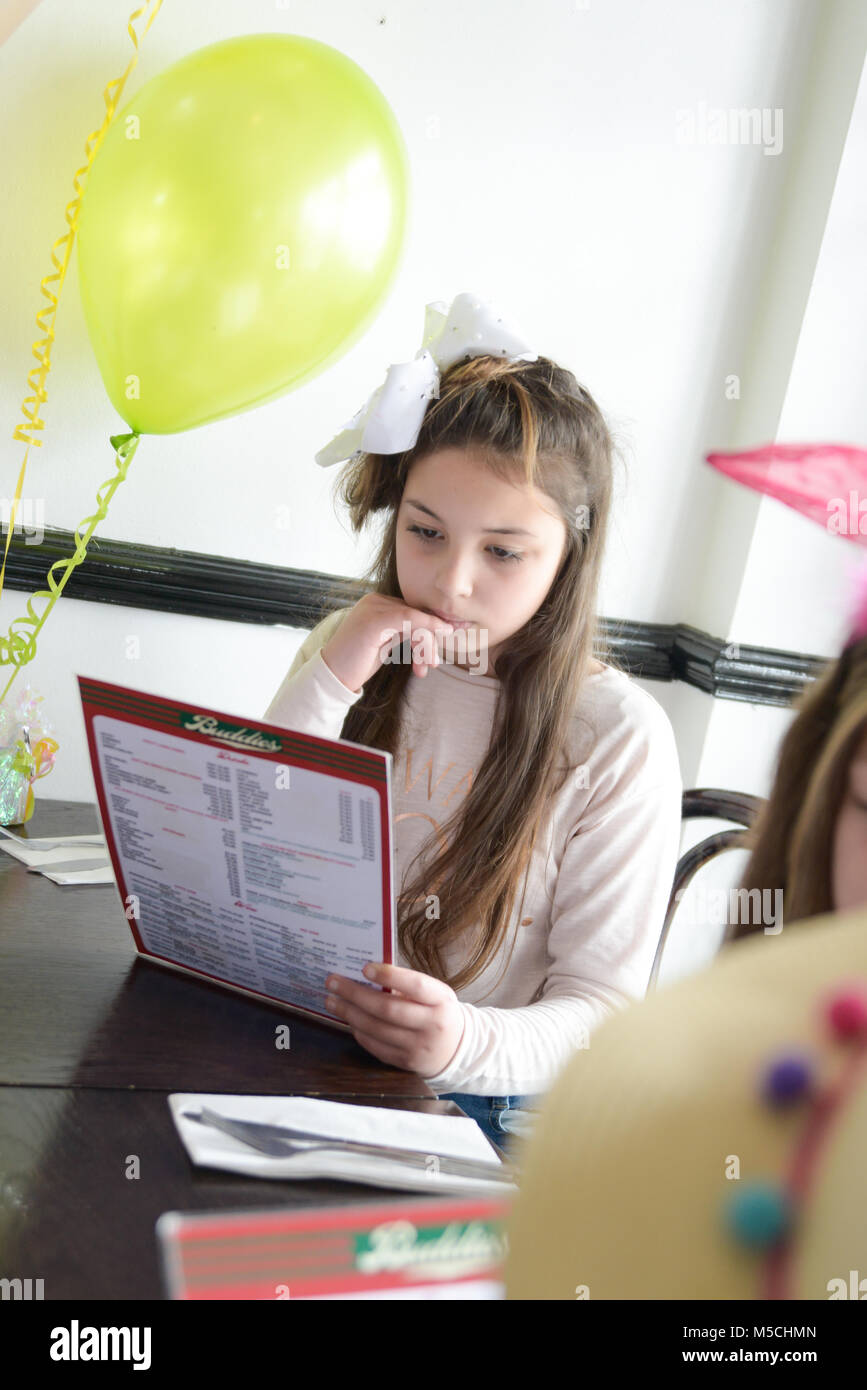 A child orders from a cafe menu at a birthday party Stock Photo - Alamy