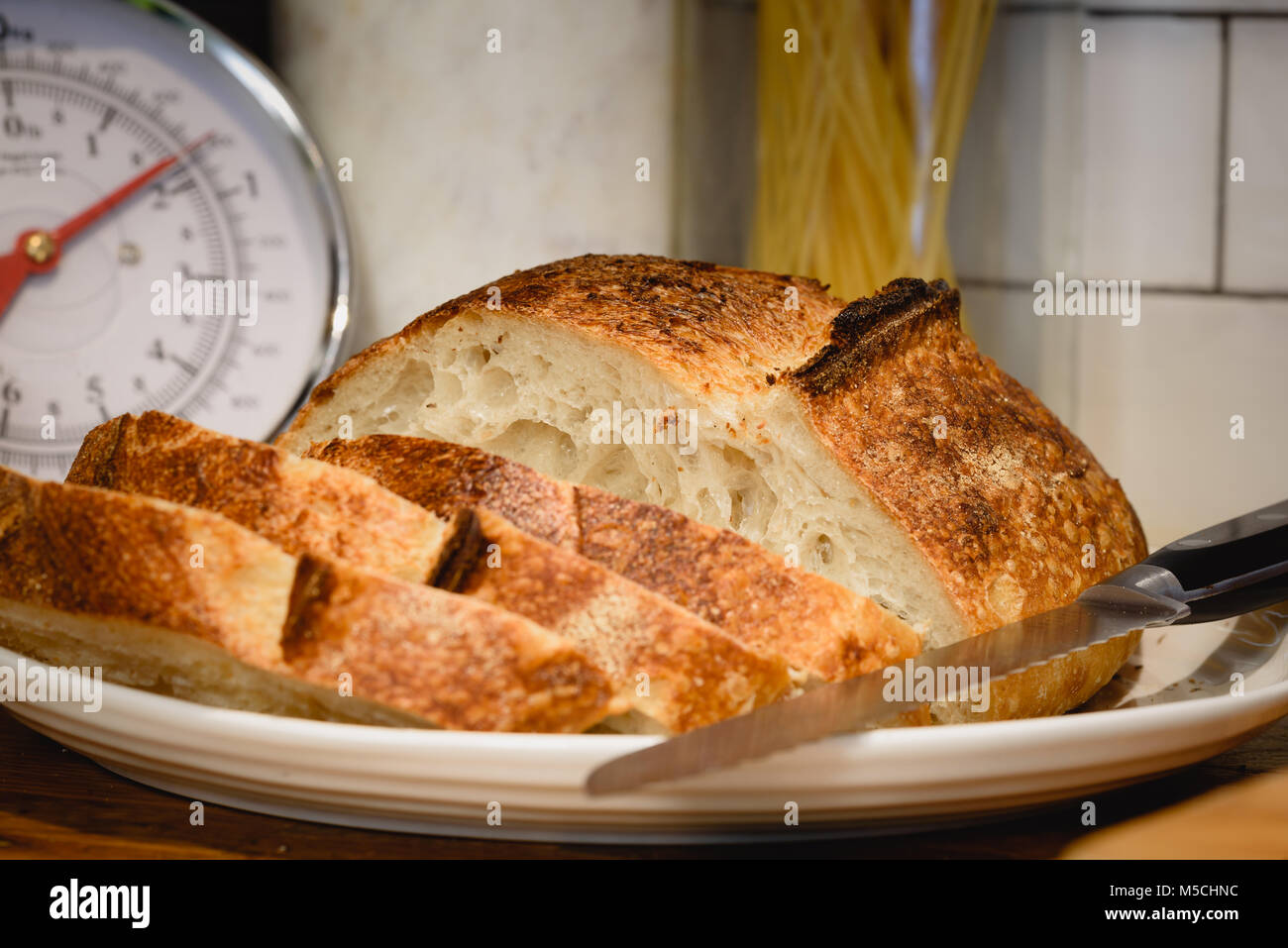 Loaf of sourdough bread partly sliced Stock Photo - Alamy