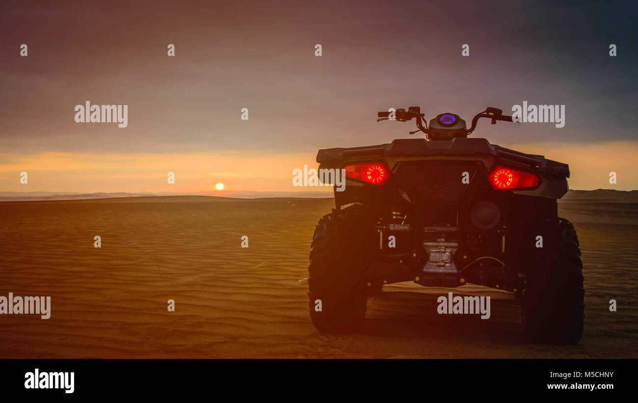 Back of an ATV on the sand watching sunset in Peru Stock Photo - Alamy