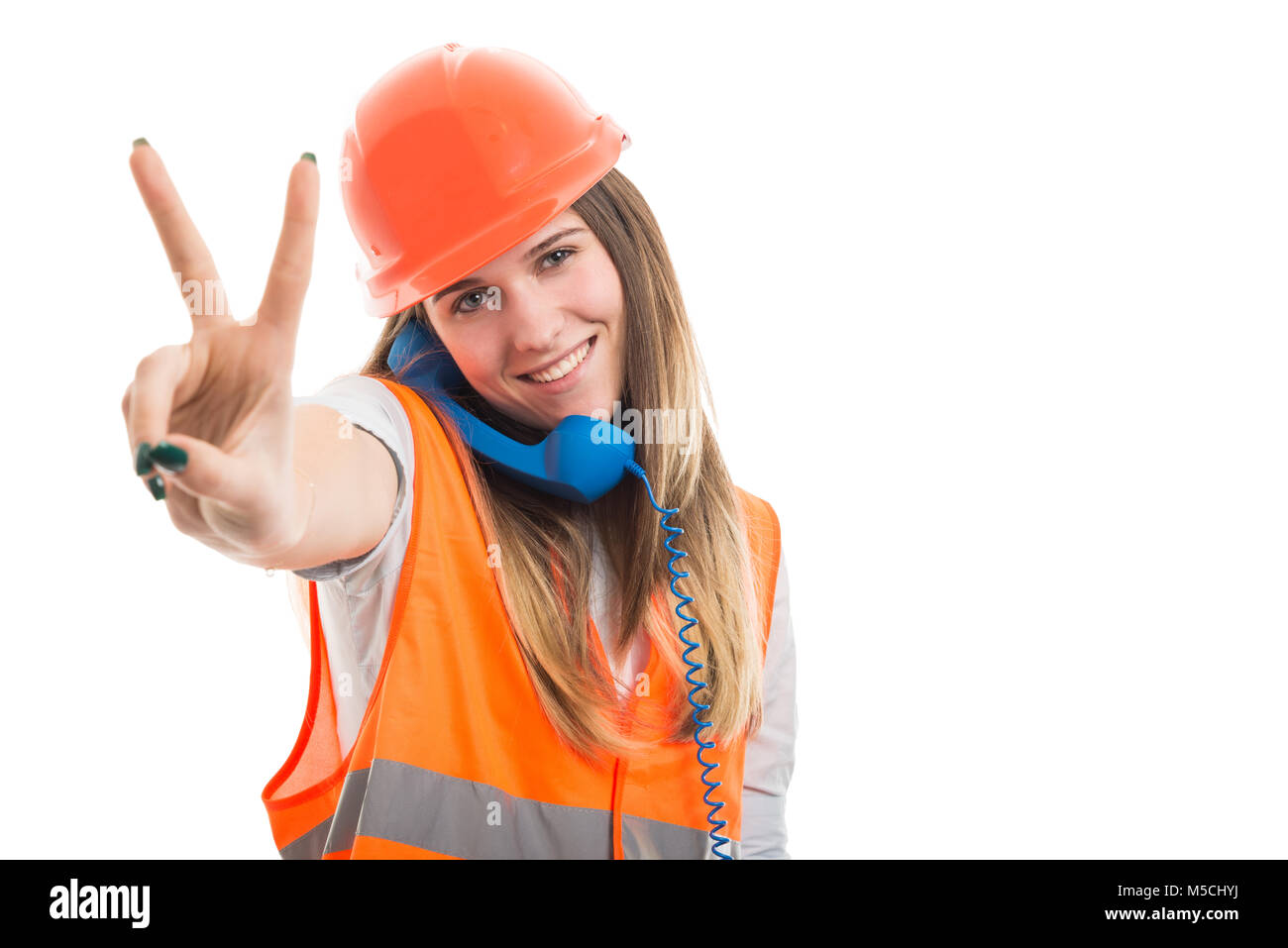 Happy pretty engineer having a conversation on telephone and showing ...