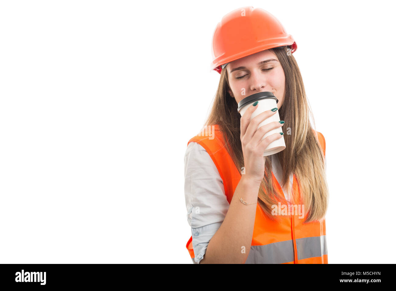 Beautiful woman engineer drinking coffee before work from disposable ...