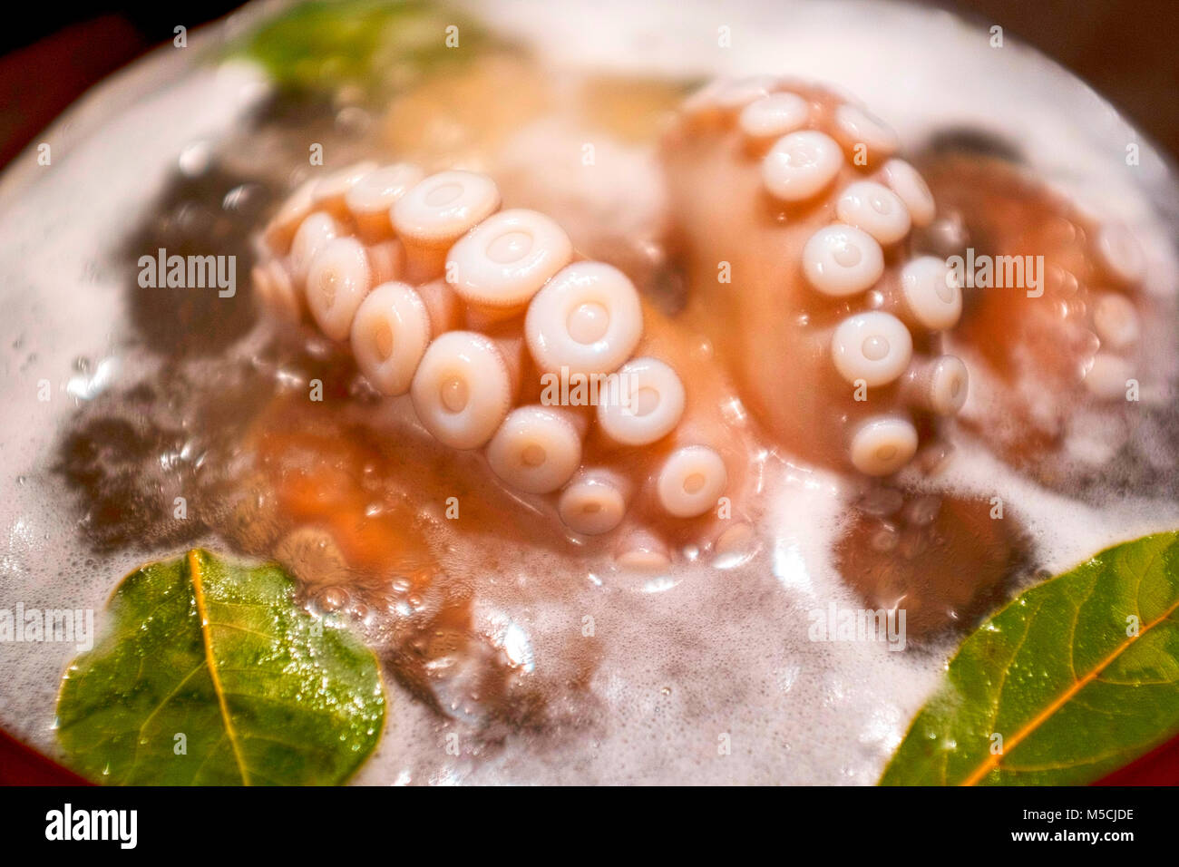 Octopus being cooked Stock Photo - Alamy