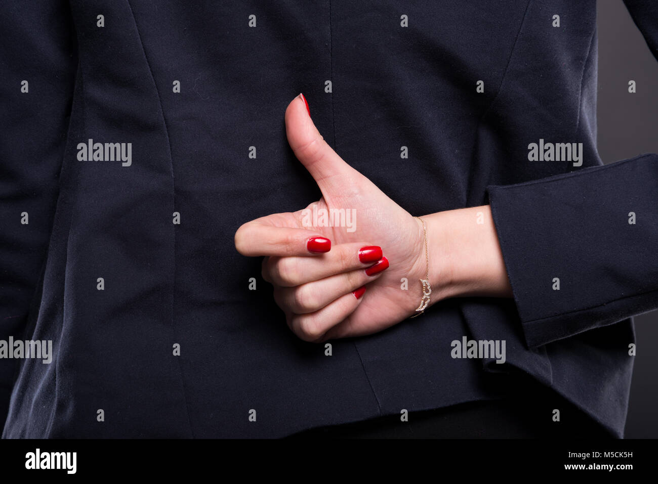 Pointing behind with her thumb hi-res stock photography and images - Alamy
