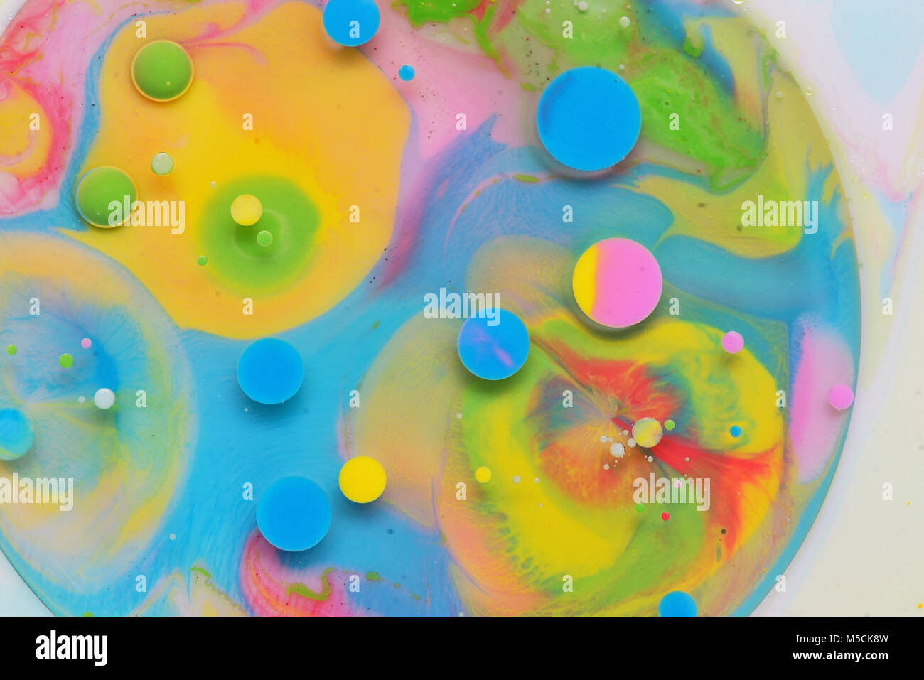 Oil, milk and water over colors Stock Photo - Alamy