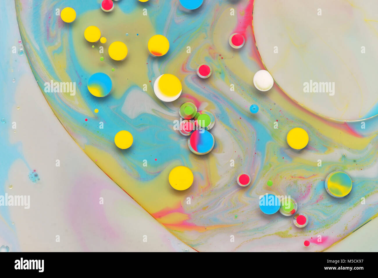 Oil, milk and water over colors Stock Photo - Alamy