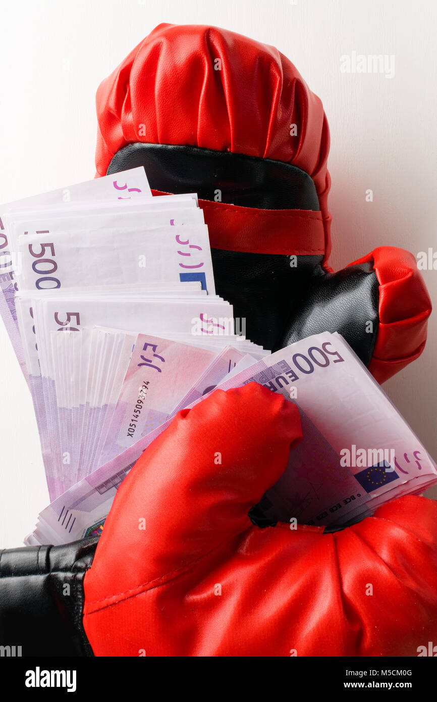 boxing for money, boxing glove with cash Stock Photo - Alamy