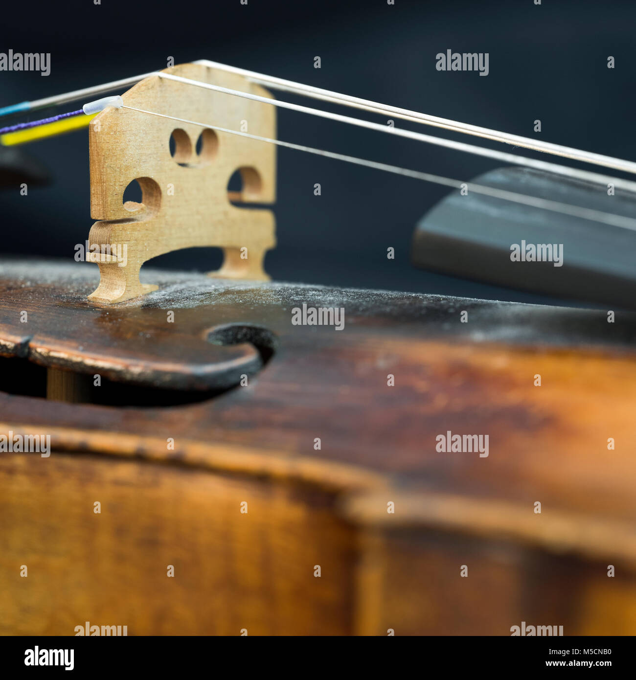 part of violin with f hole against gray background Stock Photo - Alamy