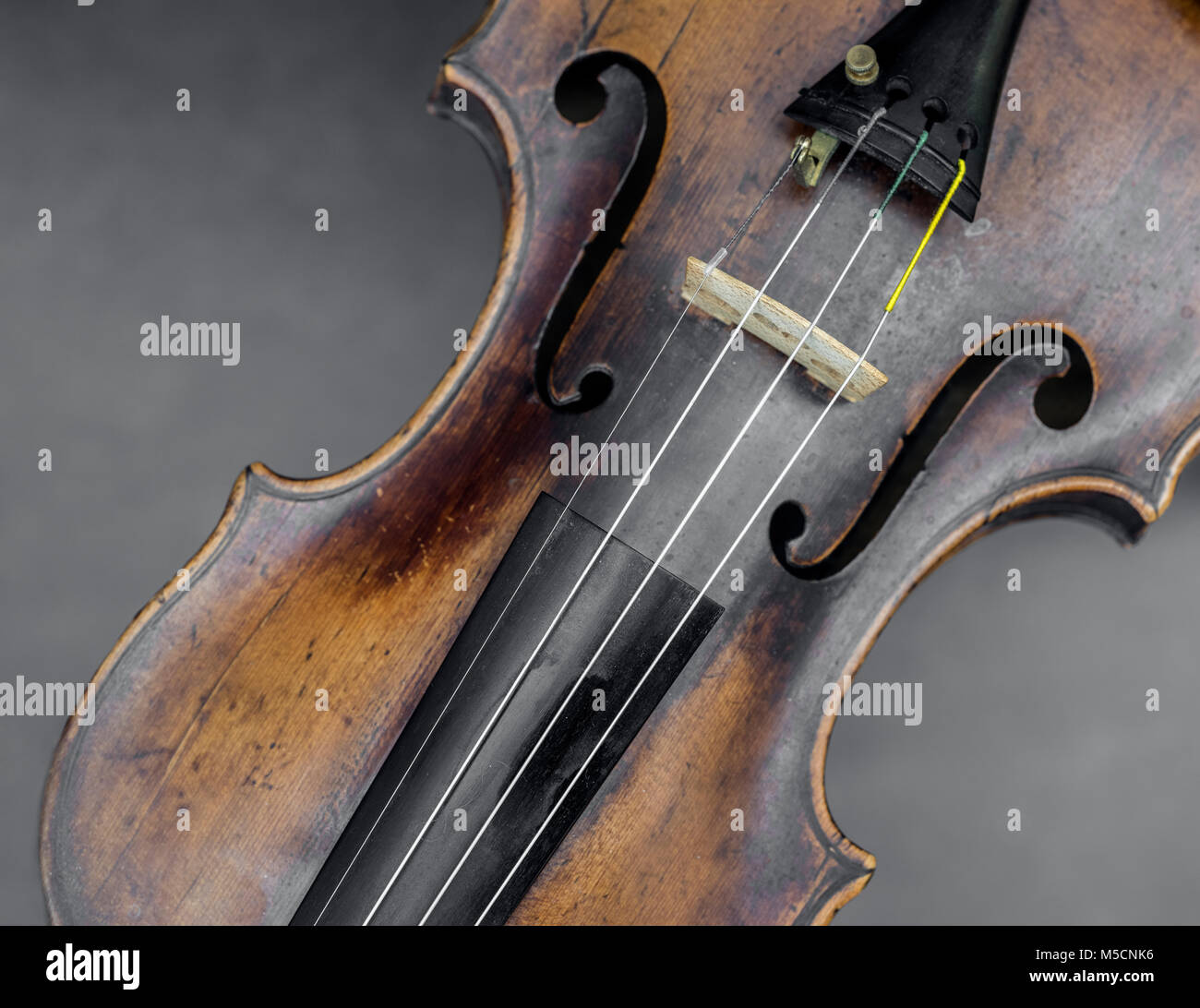 face of violin against gray background in closeup Stock Photo - Alamy