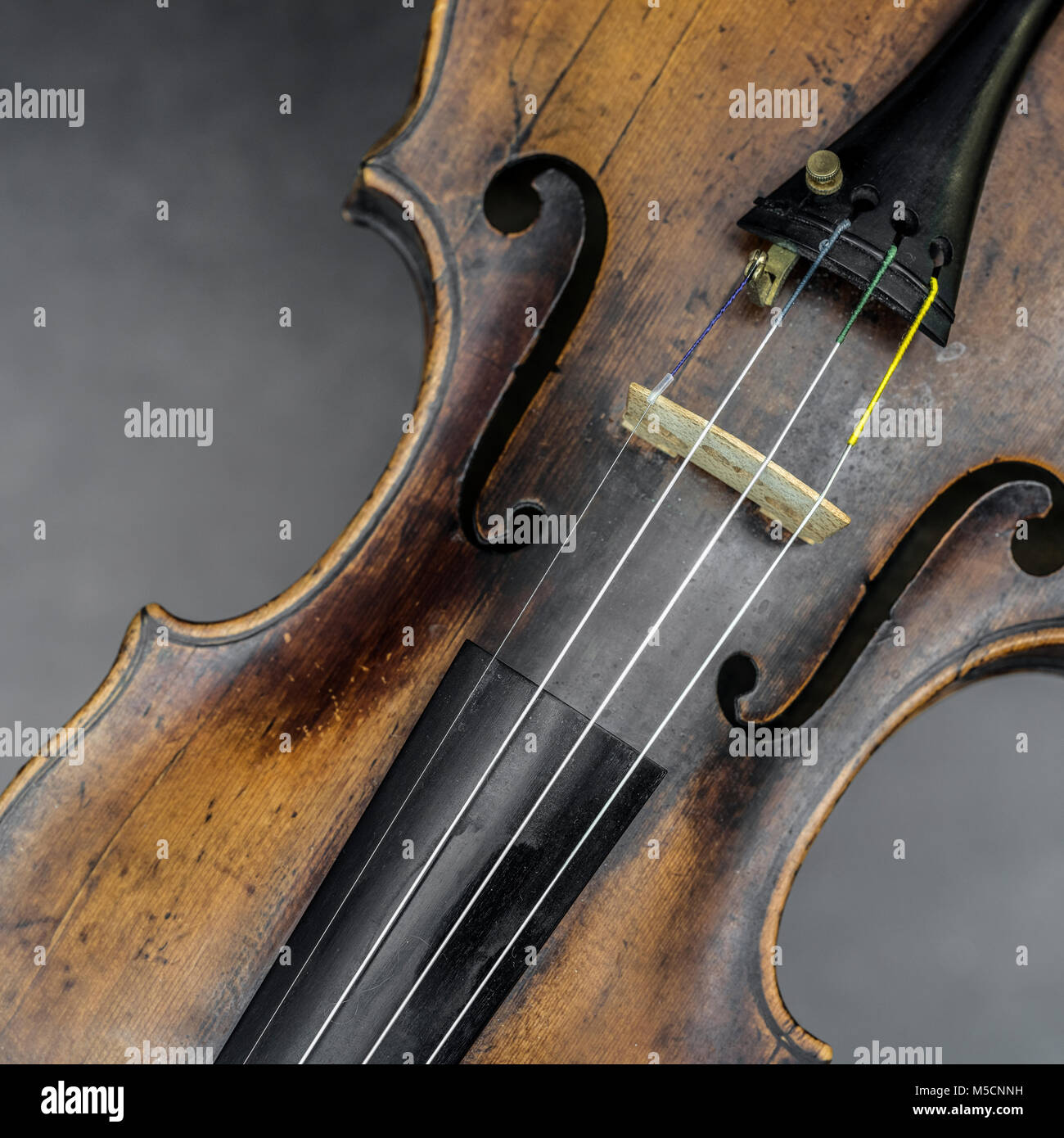 part of violin with f hole against gray background Stock Photo - Alamy