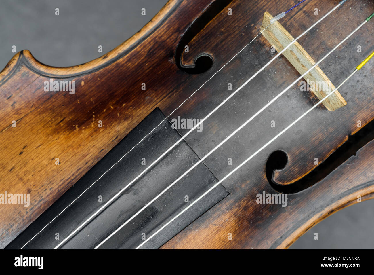 part of violin with f hole against gray background Stock Photo - Alamy