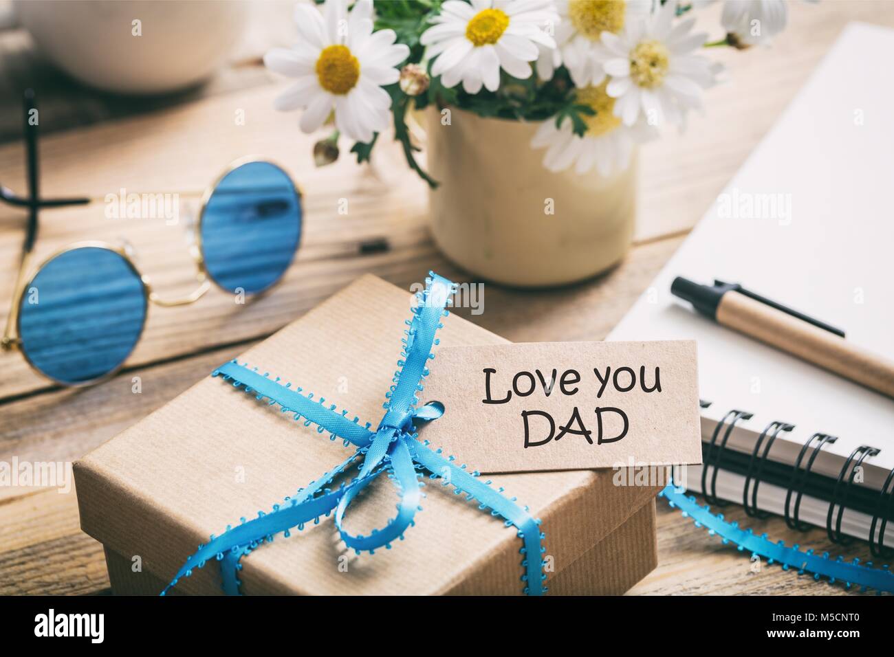 Father's day concept. Gift box with blue ribbon and love you dad tag ...