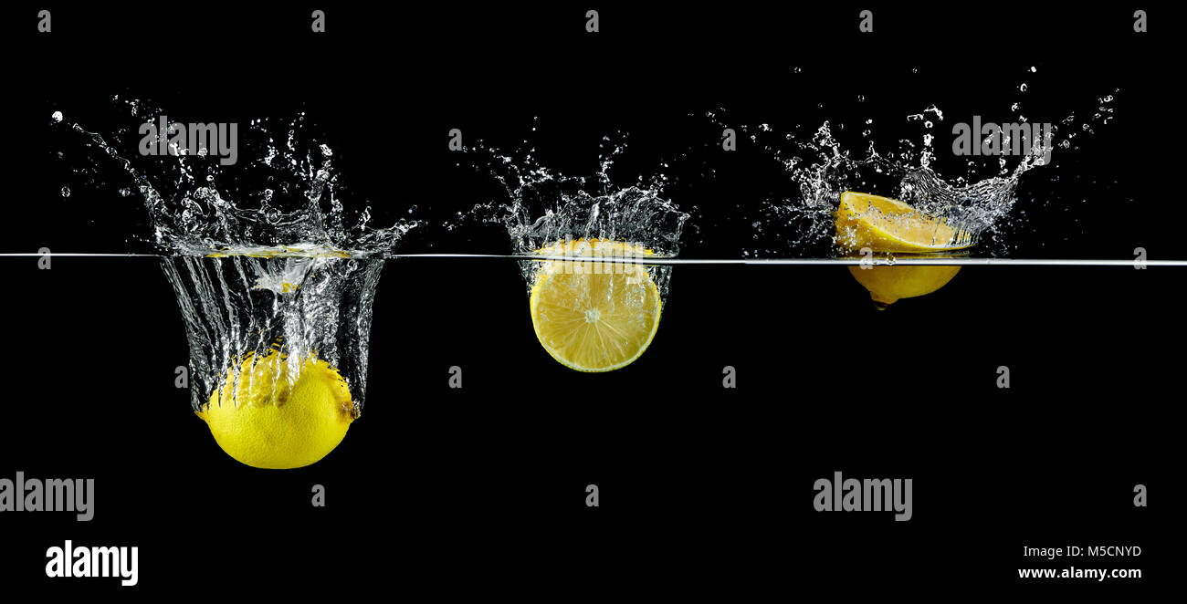 fresh yellow lemon in water splash on black background Stock Photo - Alamy