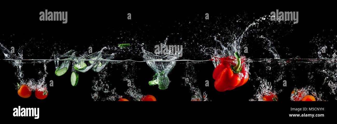 group of fresh vegetables in water splash on black background Stock ...