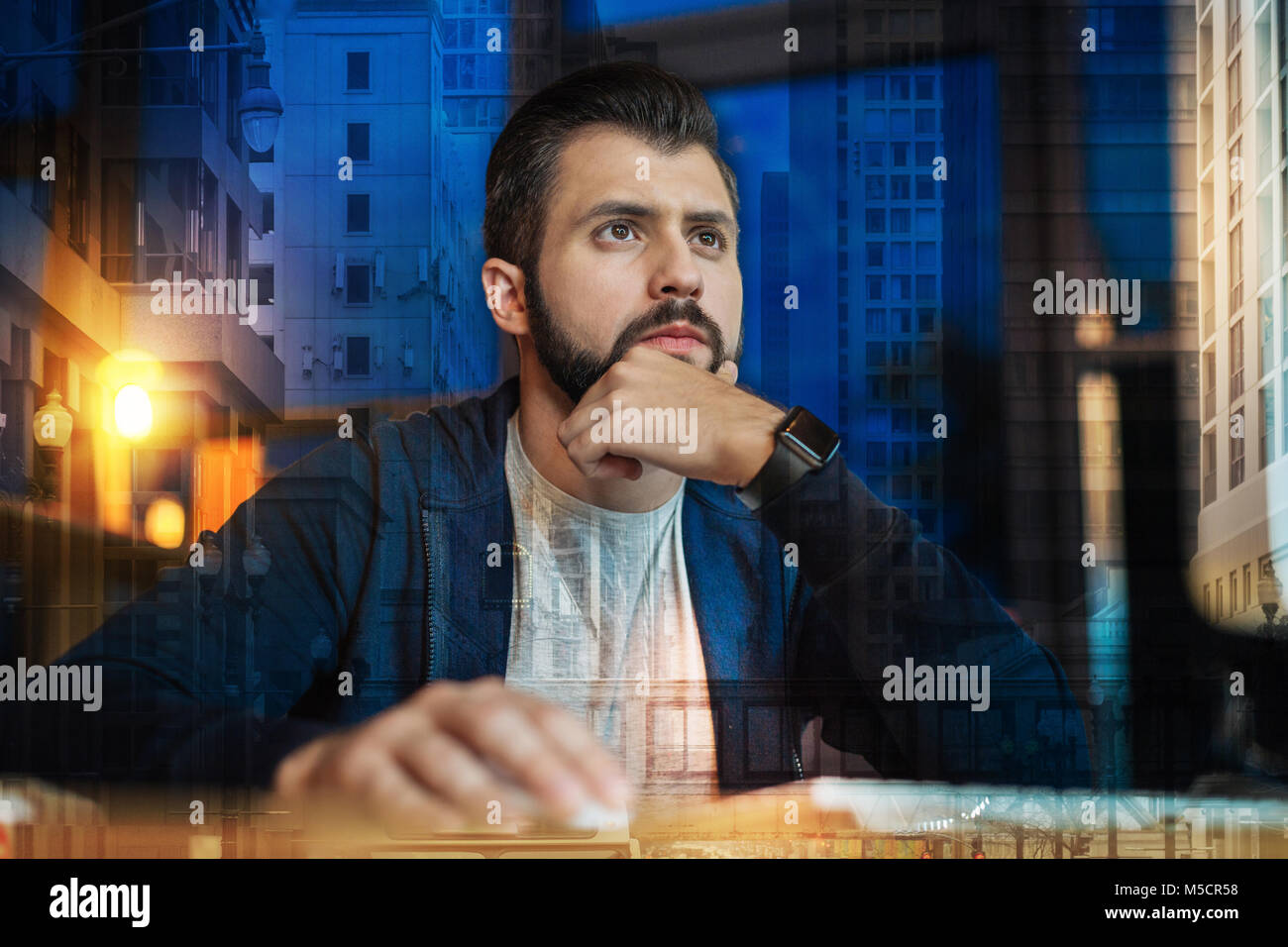 Smart man reading information for his project while sitting alone Stock ...