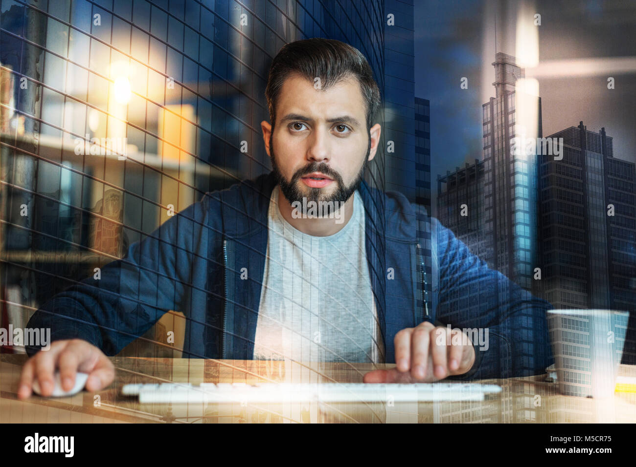 Serious worker looking at the screen and noticing strange information ...