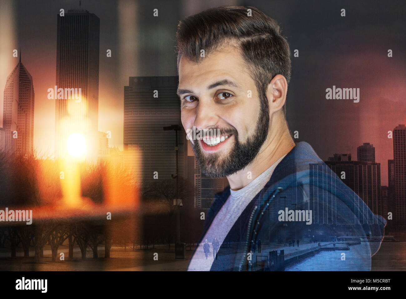 Handsome bearded man smiling while standing alone Stock Photo - Alamy