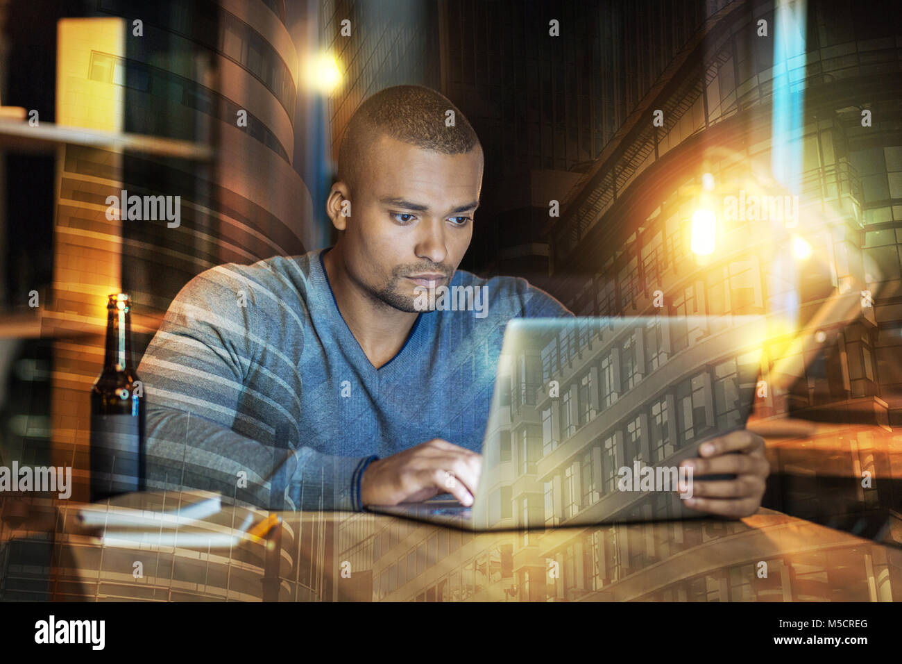 Attentive gloomy man looking at the screen and working Stock Photo - Alamy