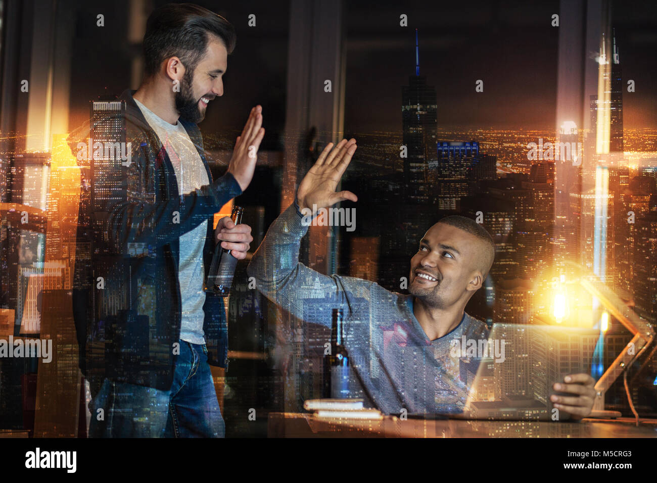 Happy young man giving five to his friend and smiling Stock Photo - Alamy