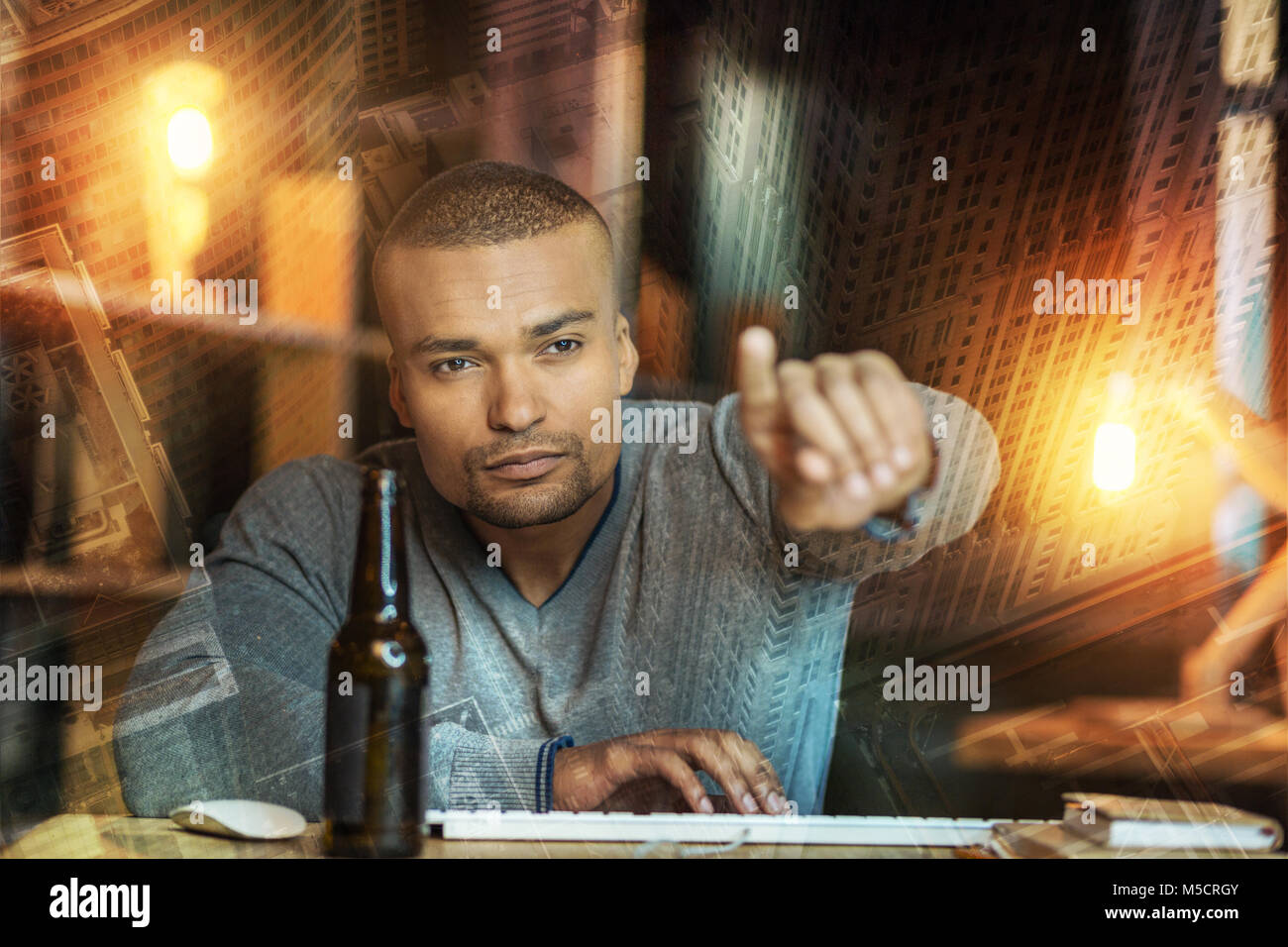 Attentive person pointing to the screen while siting with beer Stock ...
