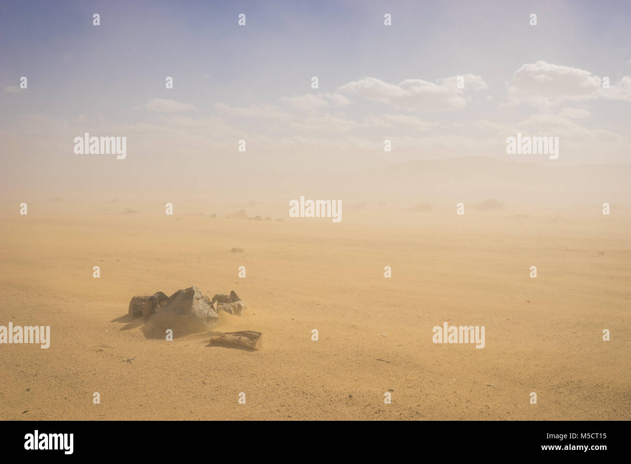 Rock stones sit in the sand in the middle of a blowing sandstorm Stock ...