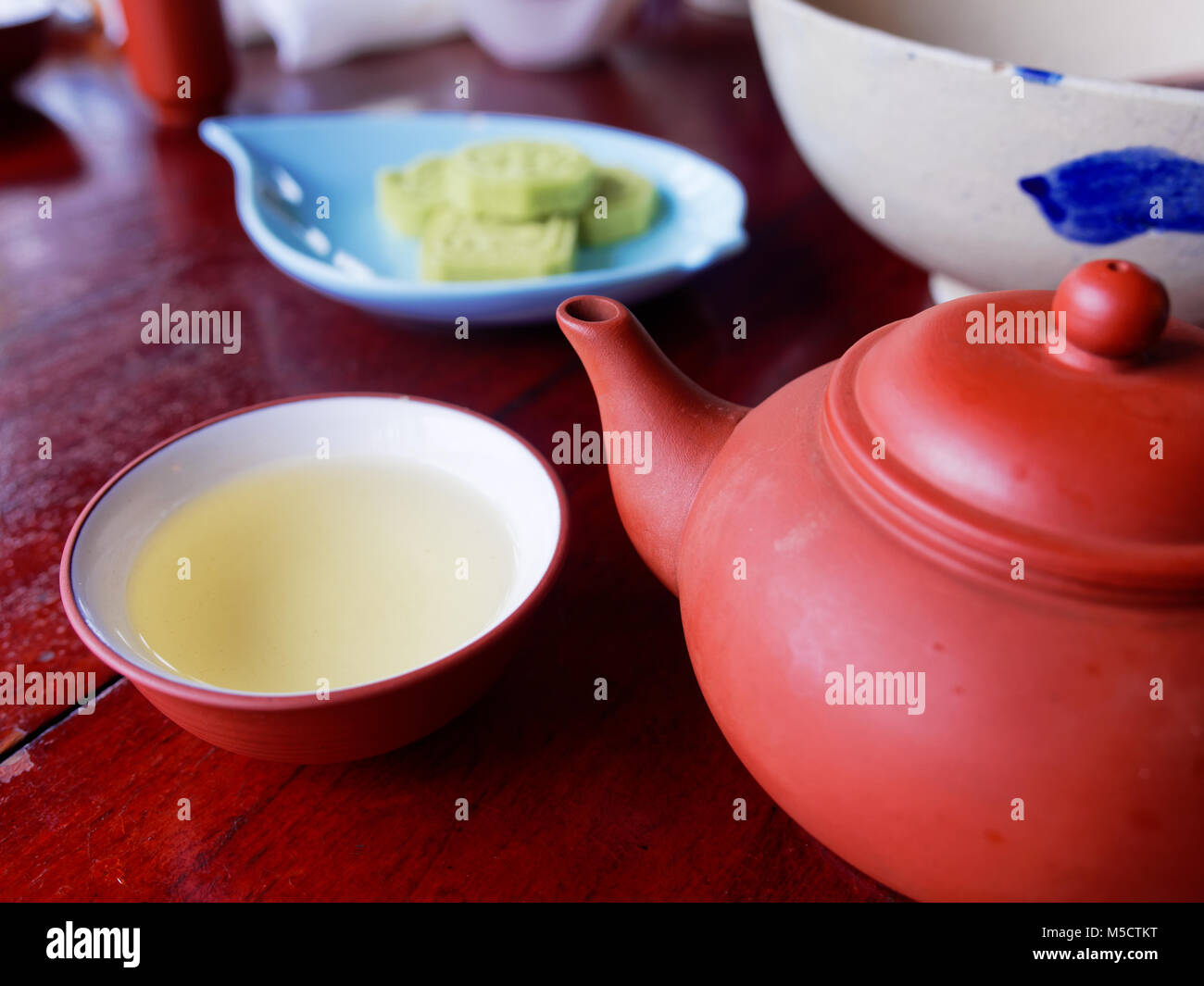 Traditional chinese tea set compose of cup of tea, teapot, and snack on ...