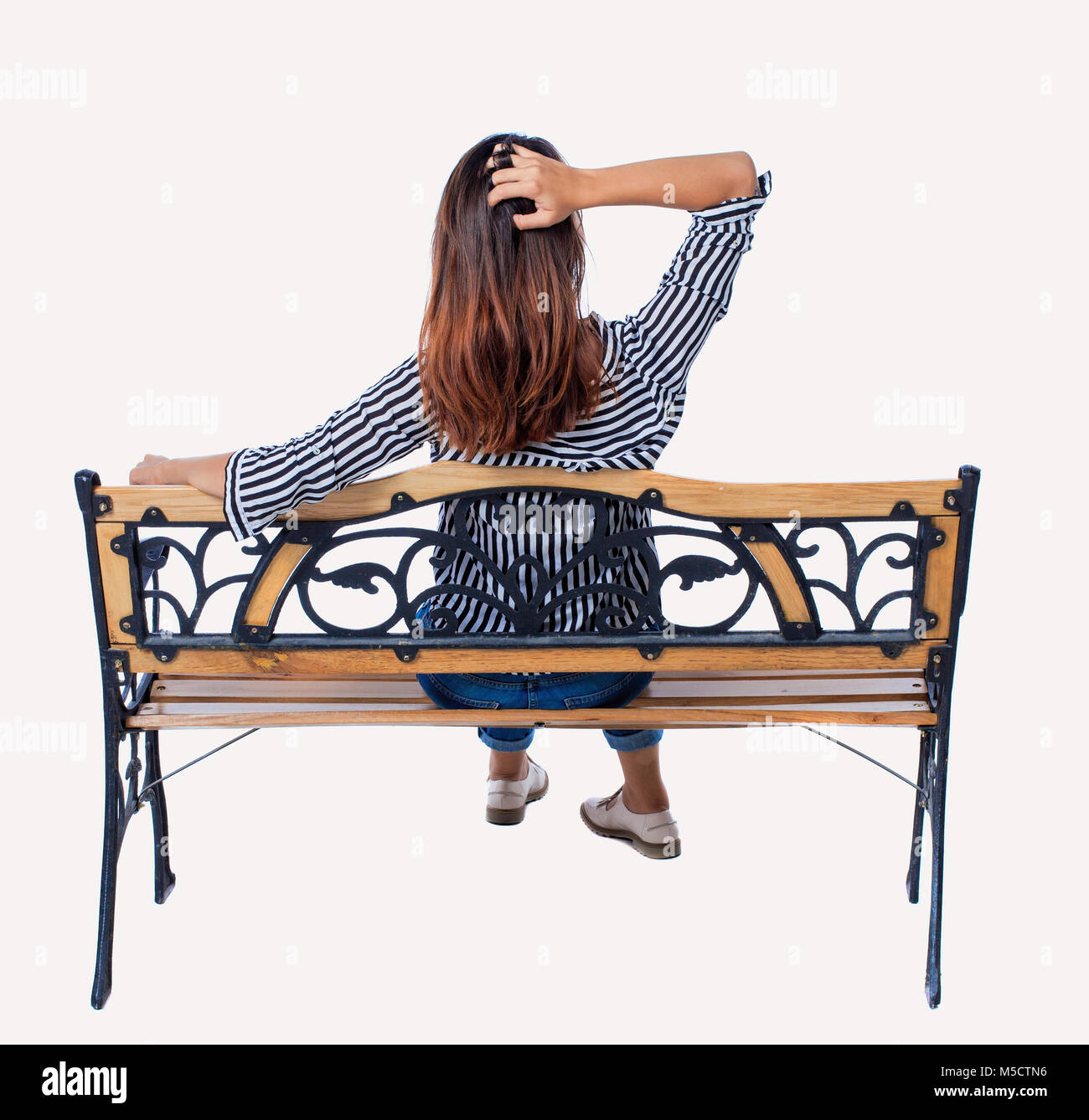 Back view of a woman sitting on a bench. girl watching. Rear view ...