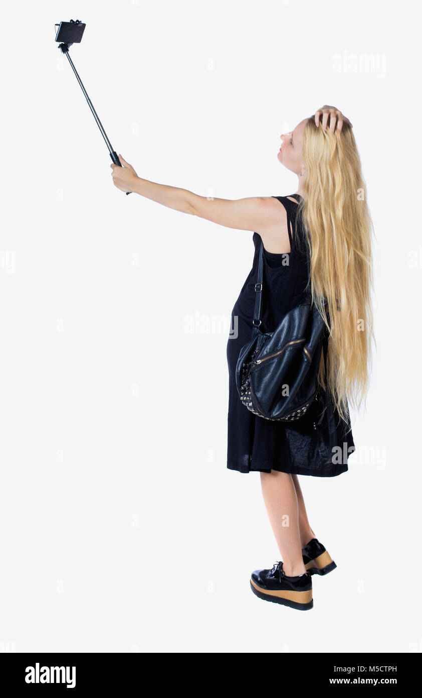 back view of standing young beautiful girl with tablet computer in the ...