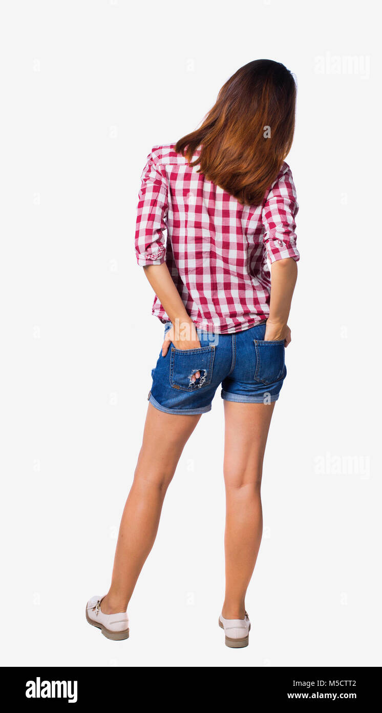 back view of standing young beautiful woman. girl watching. Rear view ...