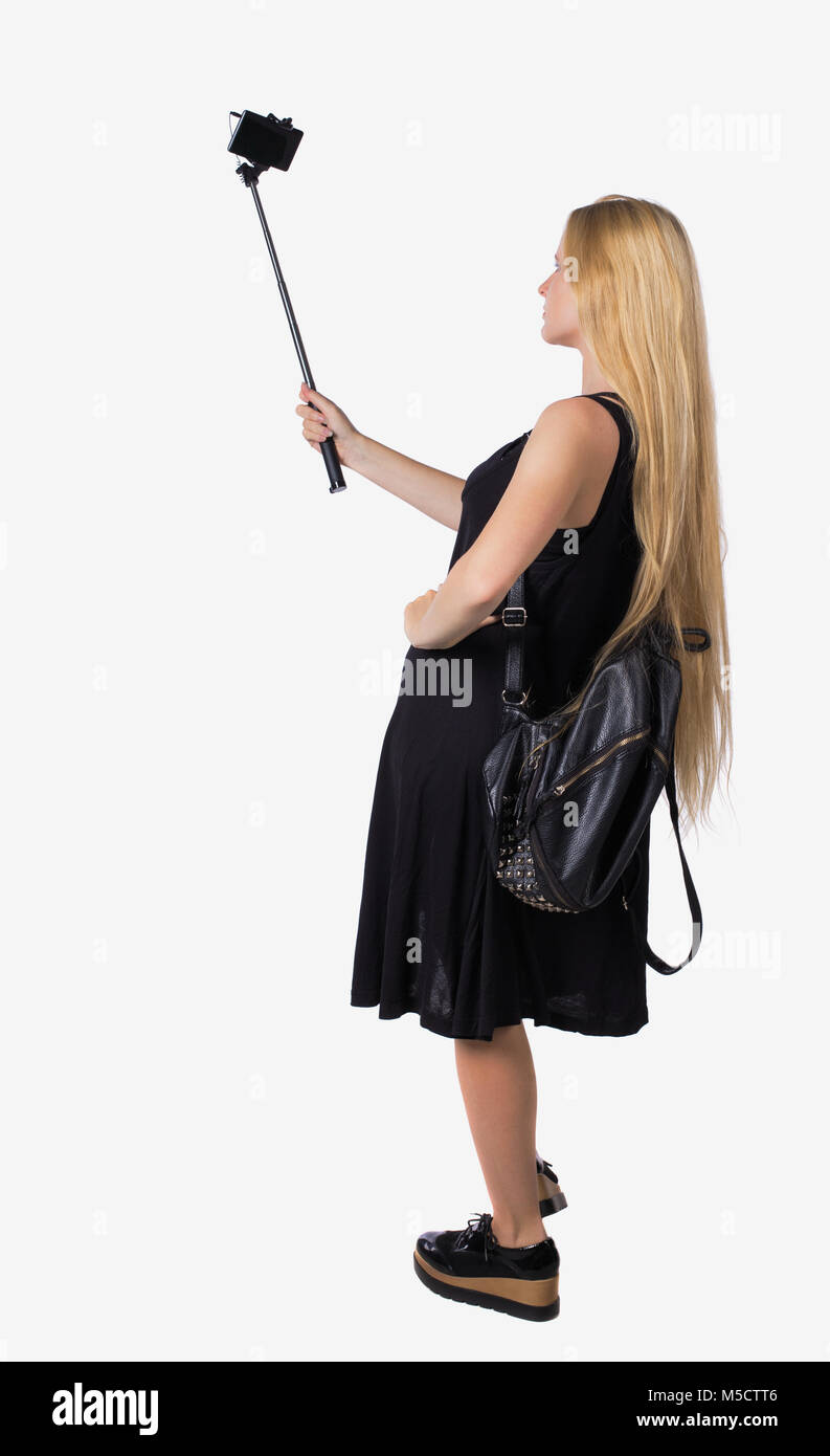 back view of standing young beautiful girl with tablet computer in the ...