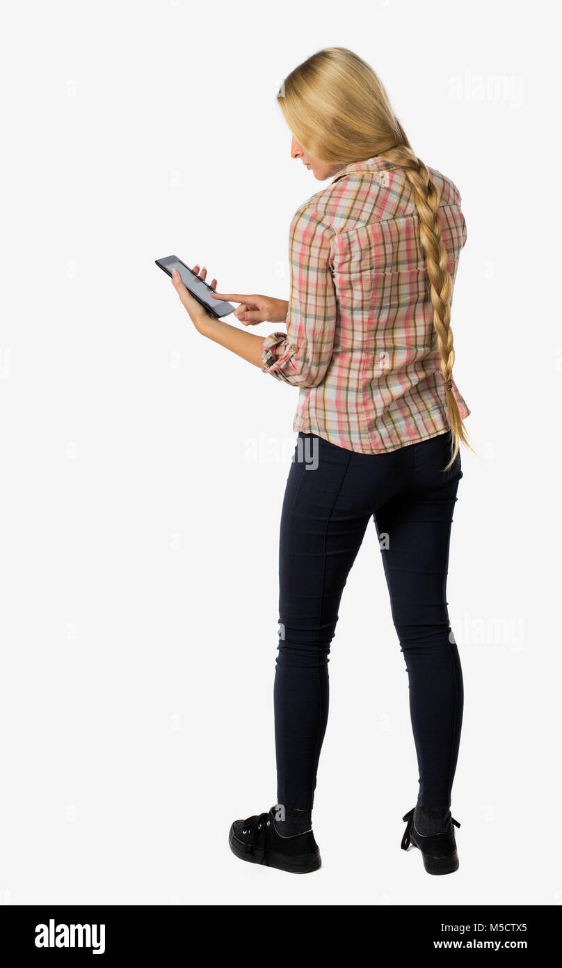 back view of standing young beautiful girl with tablet computer in the ...