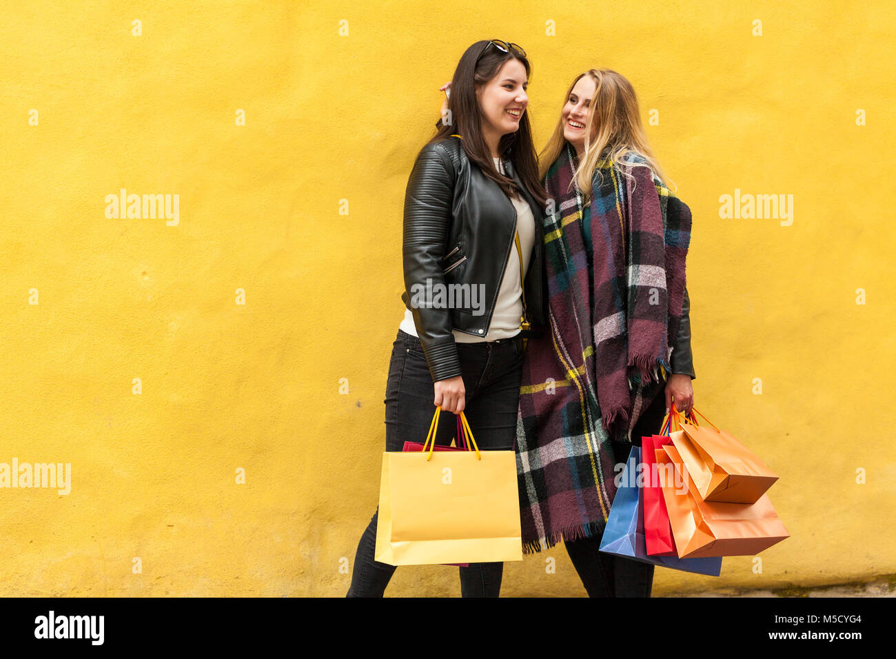 Cute smiling girls have a conversation after shopping trip Stock Photo ...