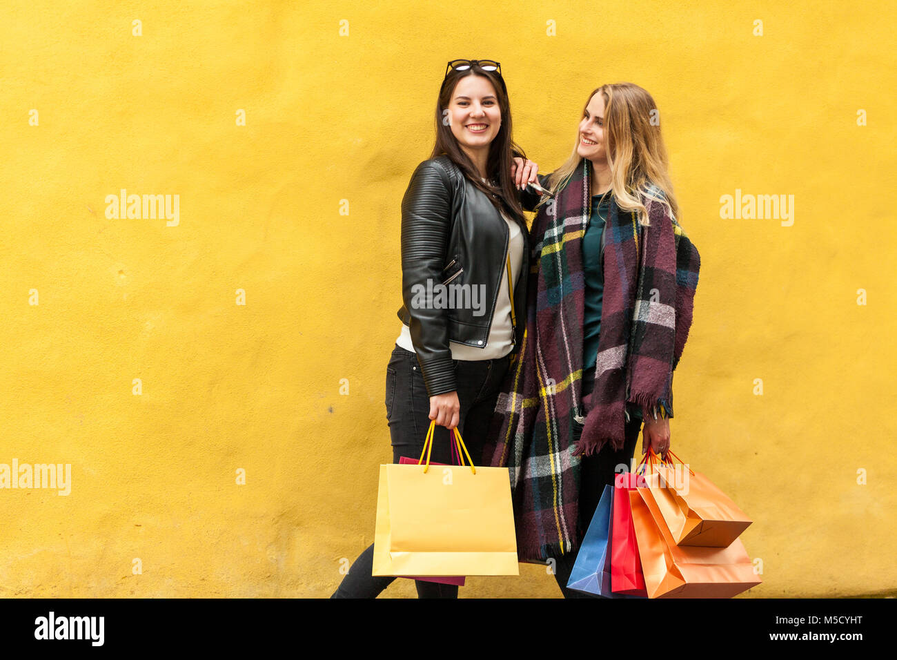Cute young girls have fun during shopping at sale day Stock Photo - Alamy