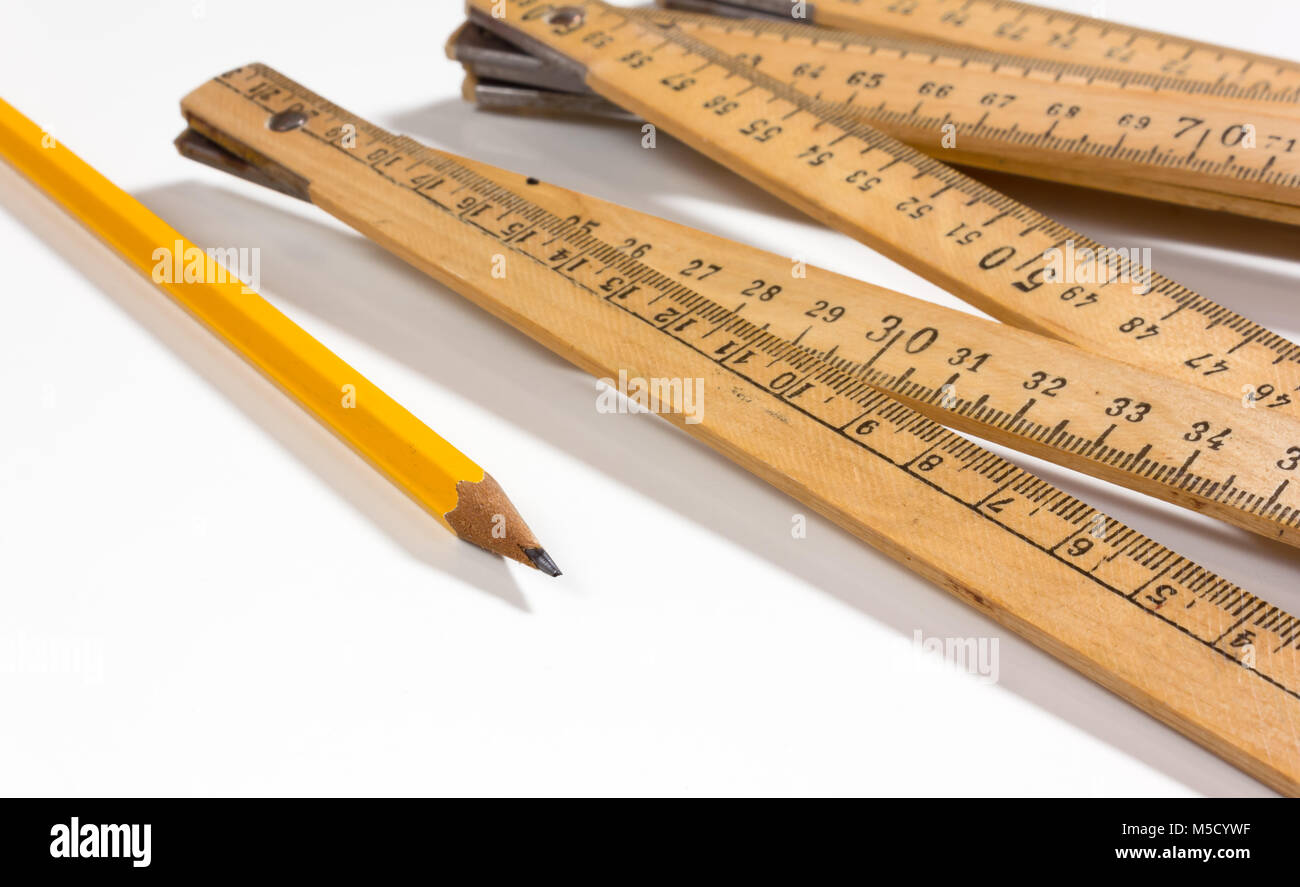 A measuring stick and a pencil on a white background Stock Photo - Alamy