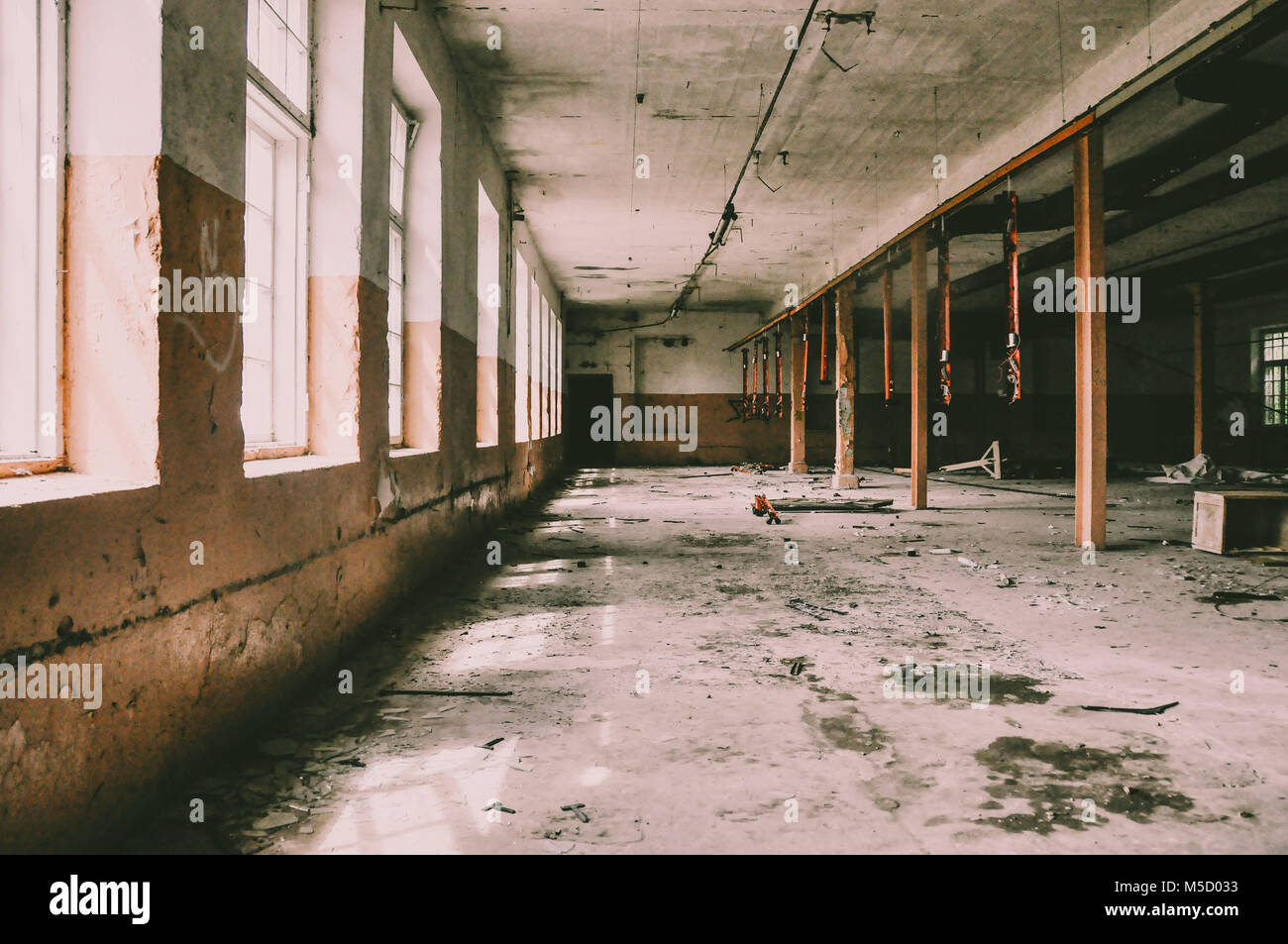 An abandoned factory. Damaged equipment. Perspective Stock Photo - Alamy