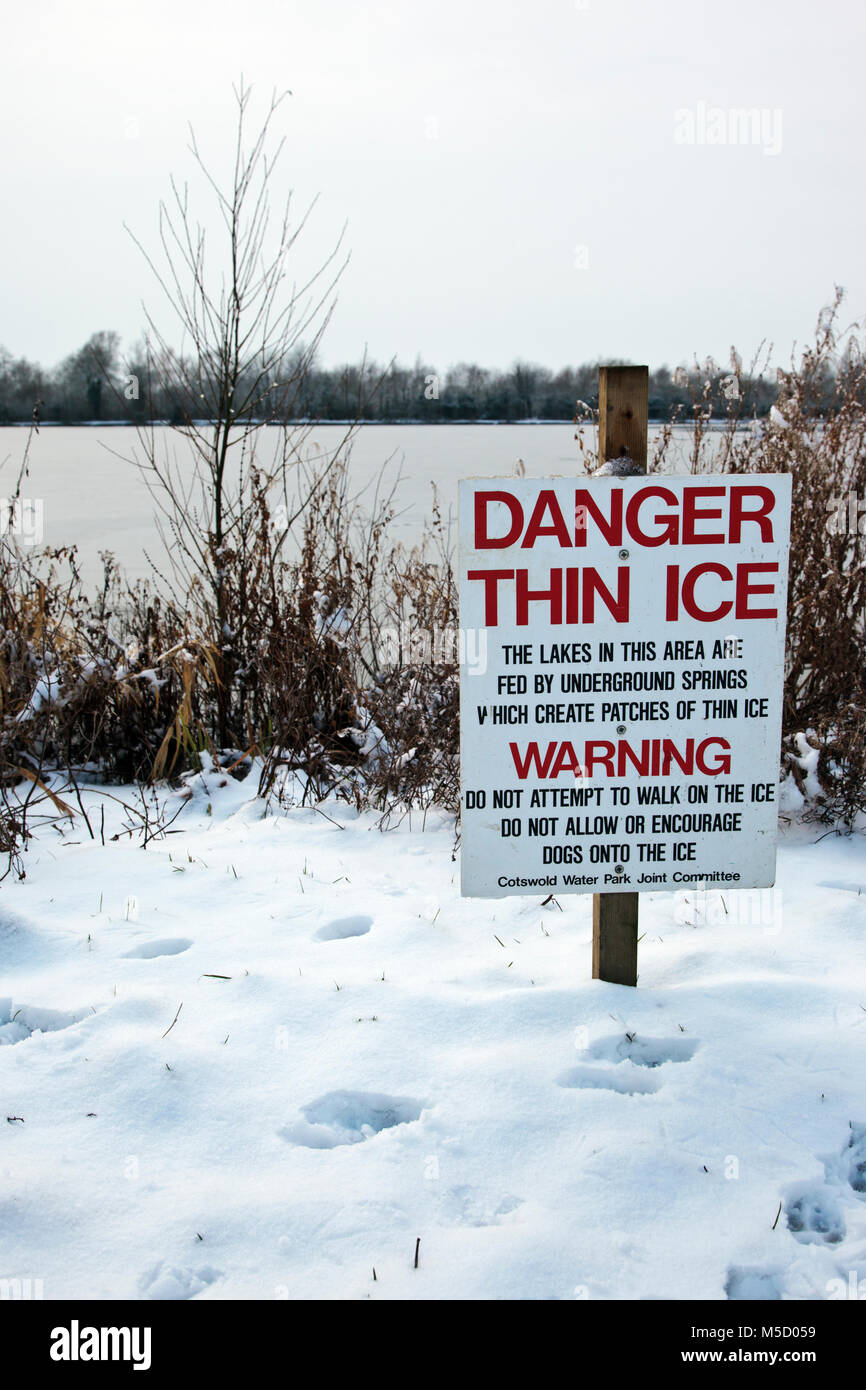 Danger Thin Ice warning sign next to a frozen lake at Neighbridge ...