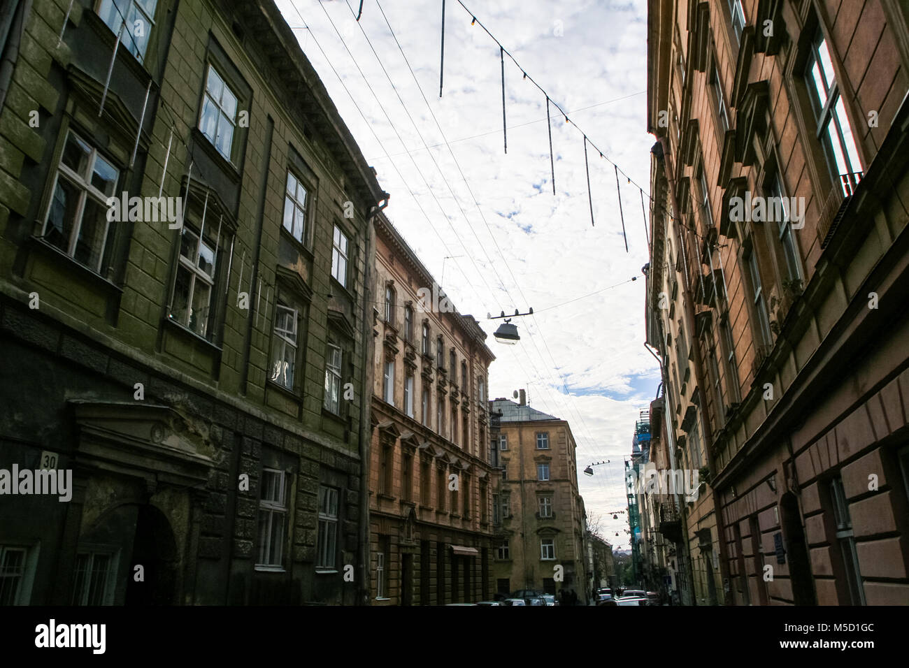 silhouettes of age-old houses in shadow street with street lights and ...