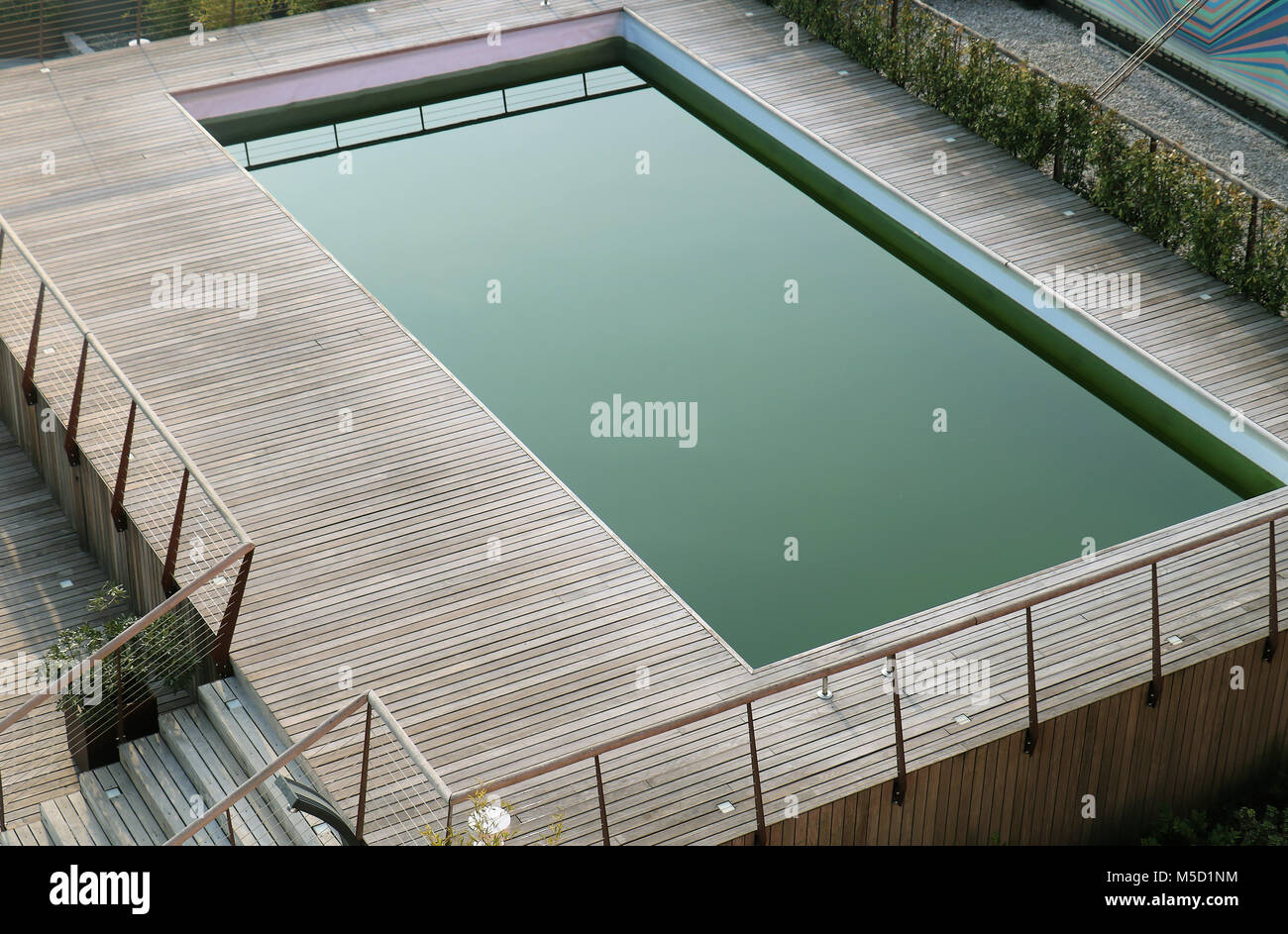 Outdoor swimming pool on the roof with wooden floor Stock Photo - Alamy