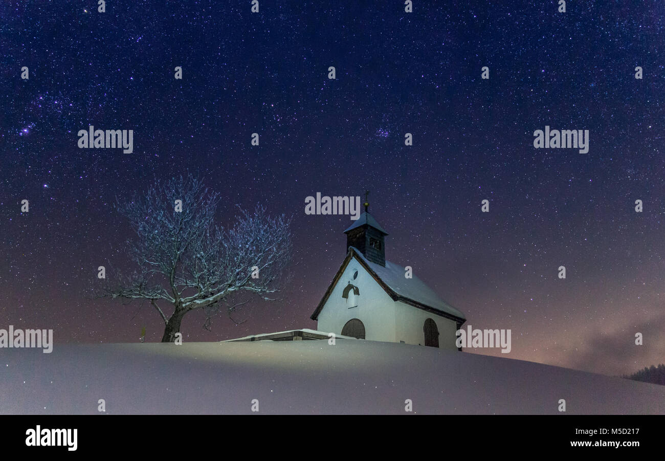 Fantastic stary winter night with small chapel Stock Photo - Alamy