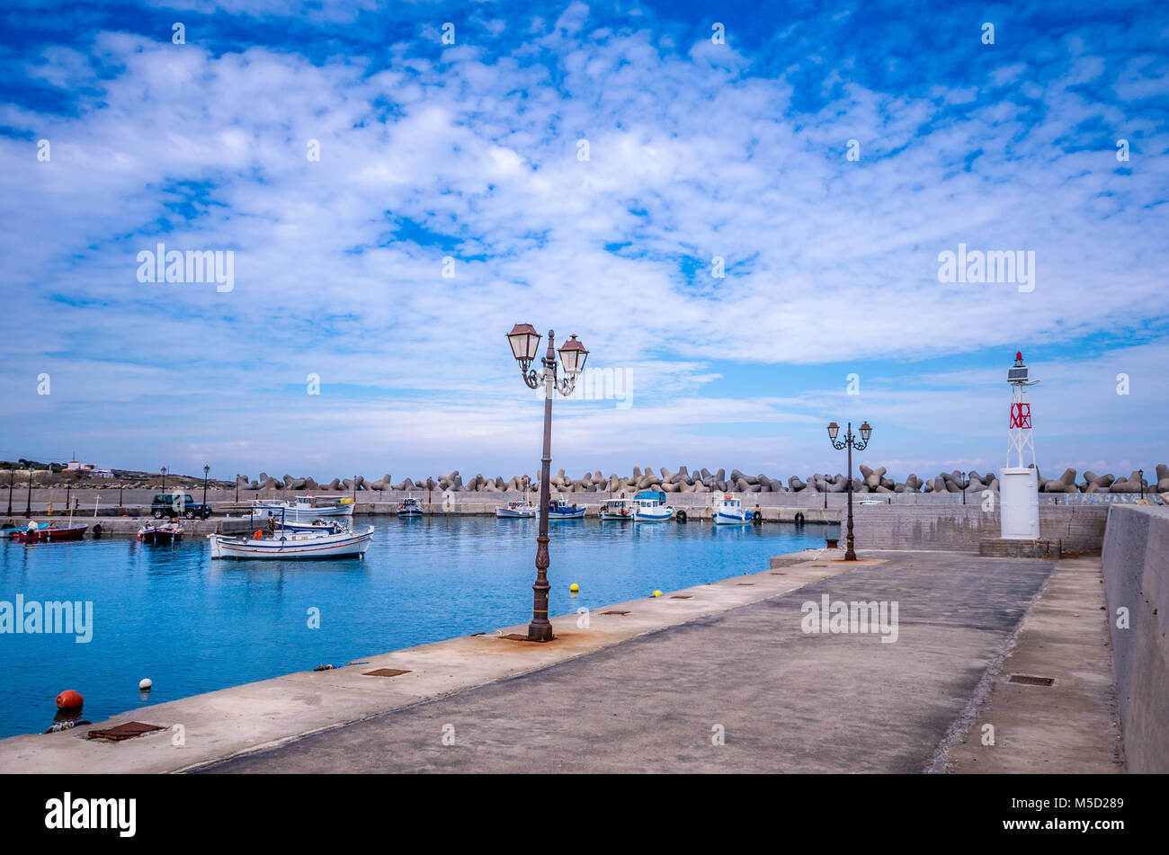 Traditional fishing village of northern Crete with small harbour, rusty ...