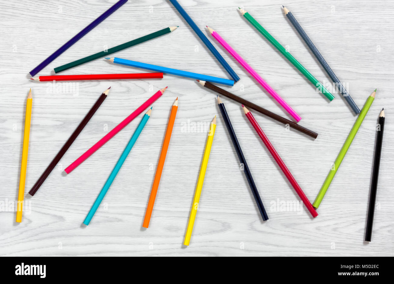 Colored pencils scattered across a white wooden background Stock Photo ...