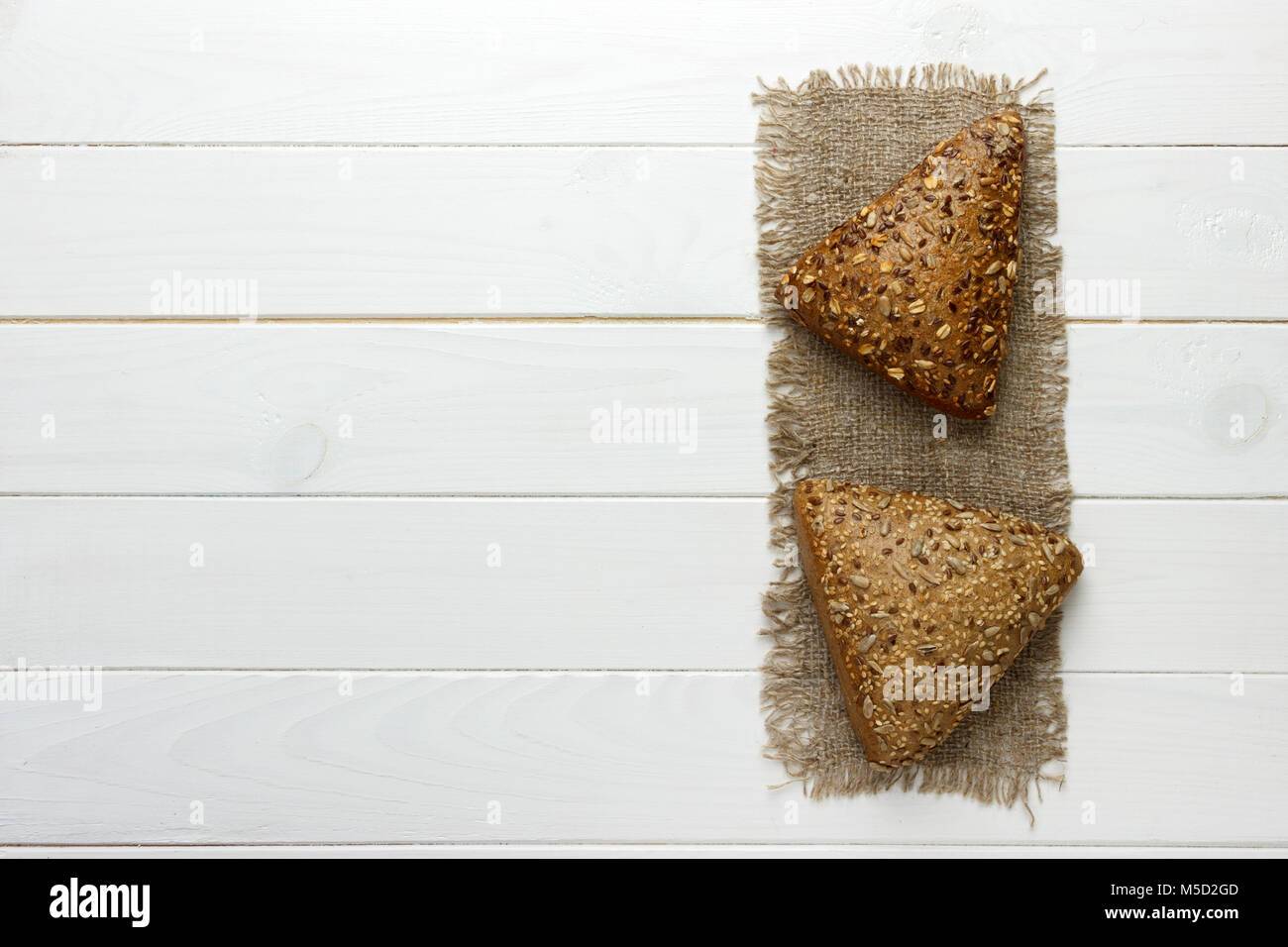 Several small multi grain triangular shaped bread sprinkled with whole ...